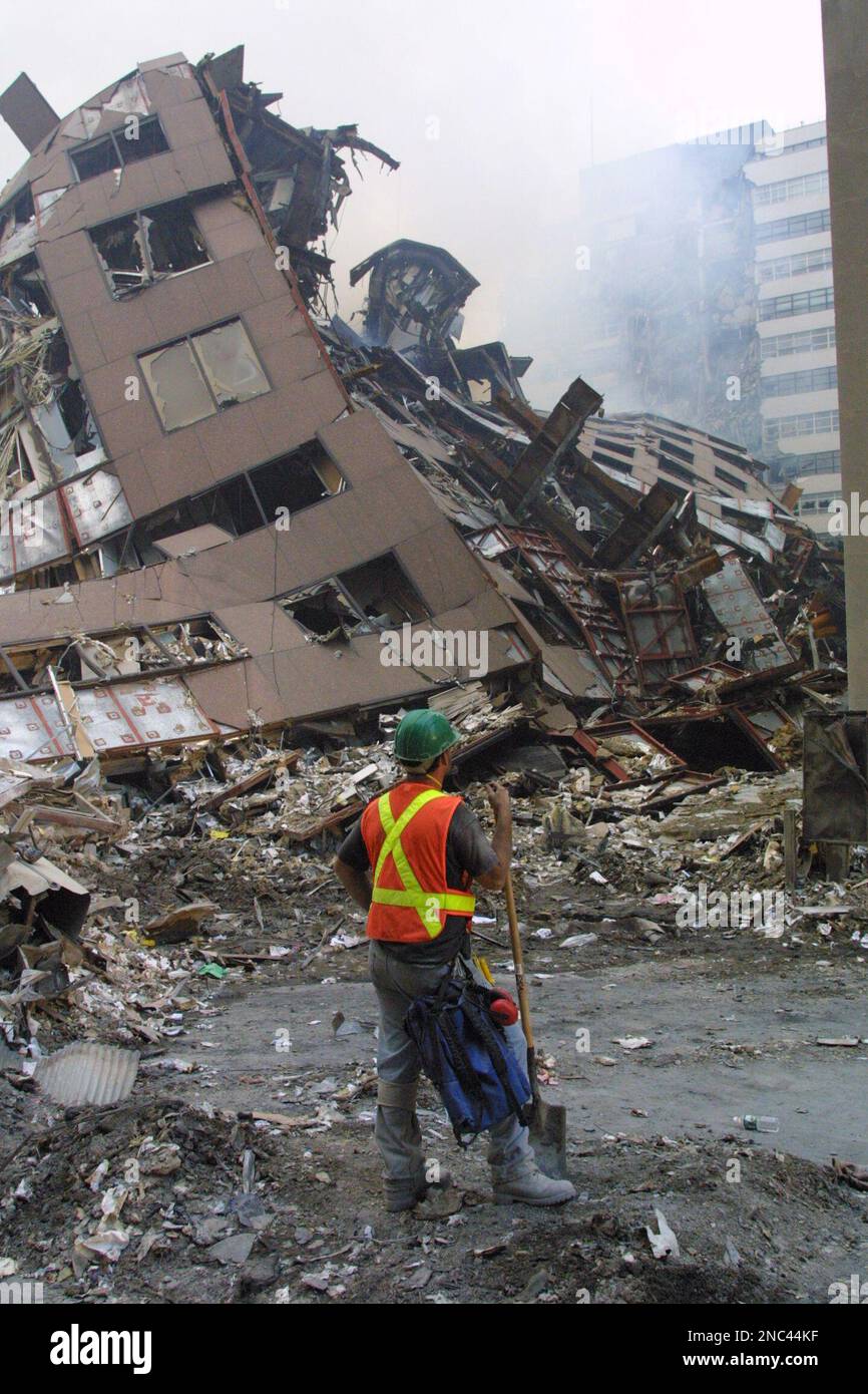 In this September 14, 2001 photograph, a worker observes the rubble at ...