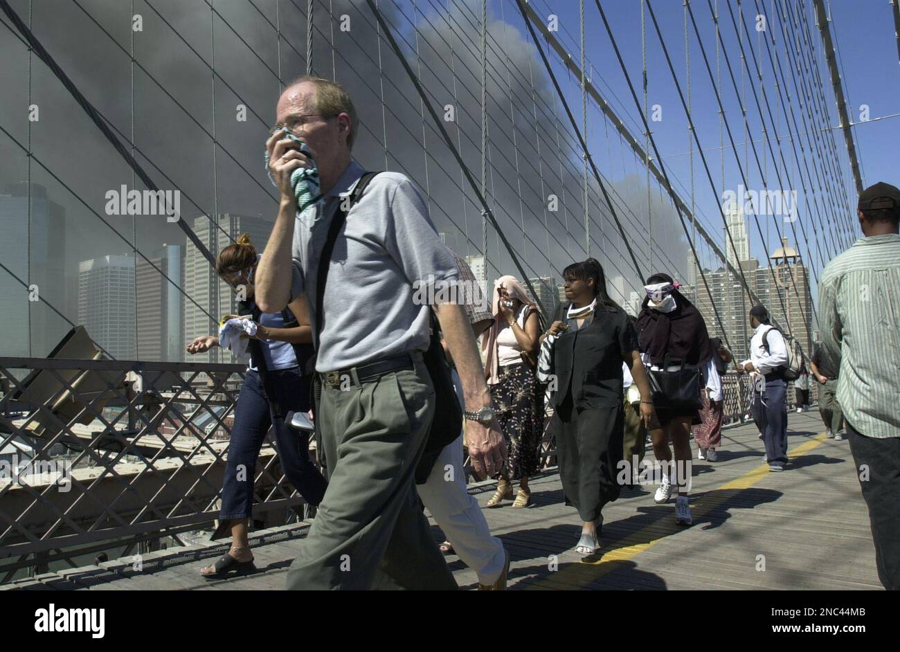In this Sept. 11, 2001 photo, people walk over New York's Brooklyn ...