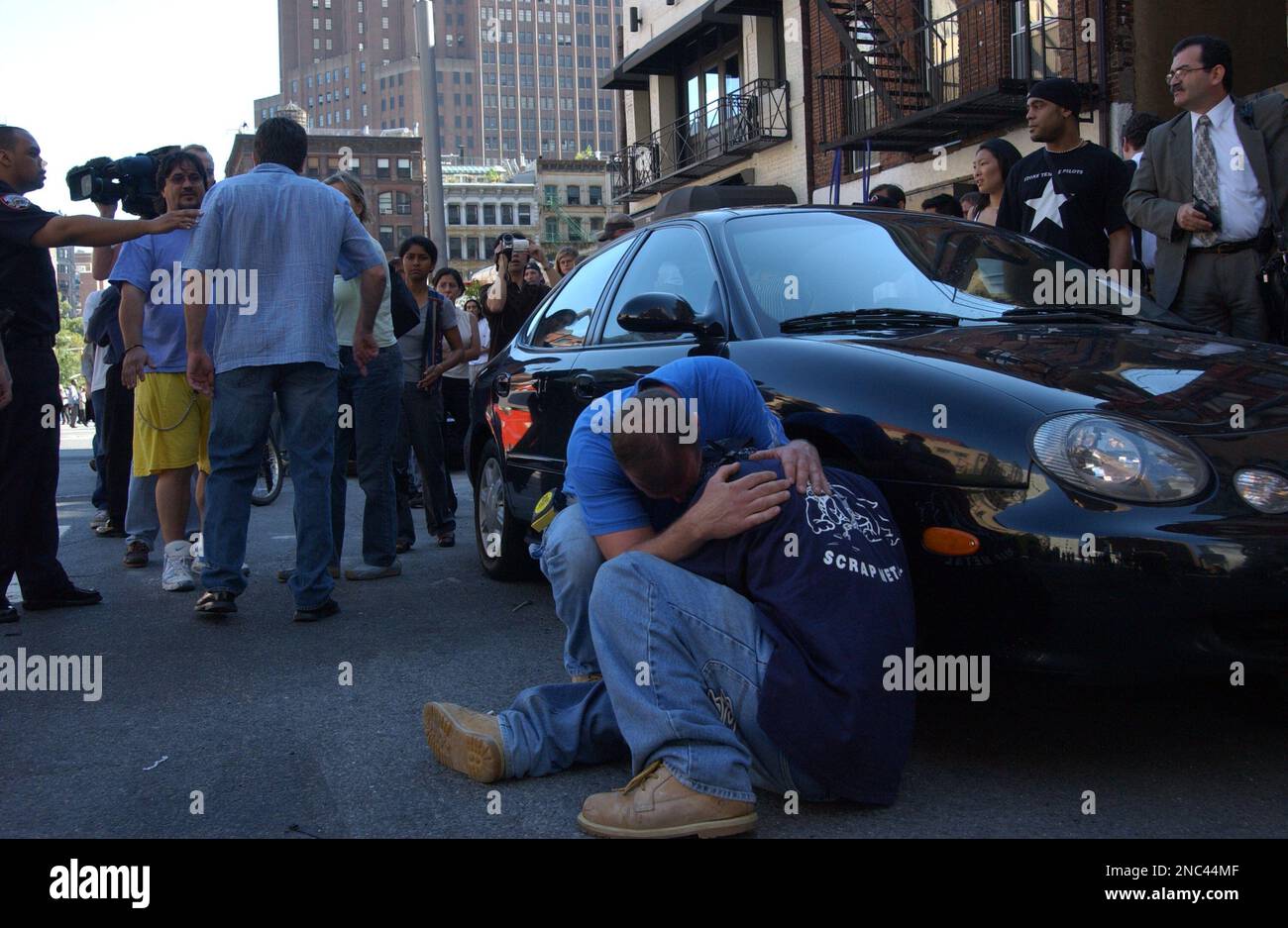 Two men hug in downtown Manhattan in response to the collapse of the ...
