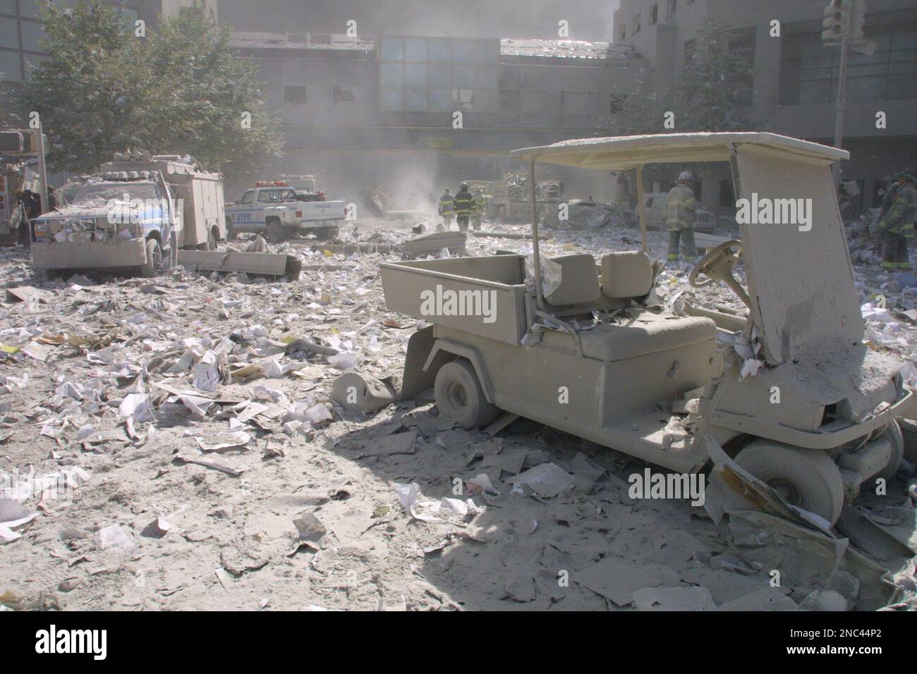 Firefighters walk through the rubble in the aftermath of the September ...