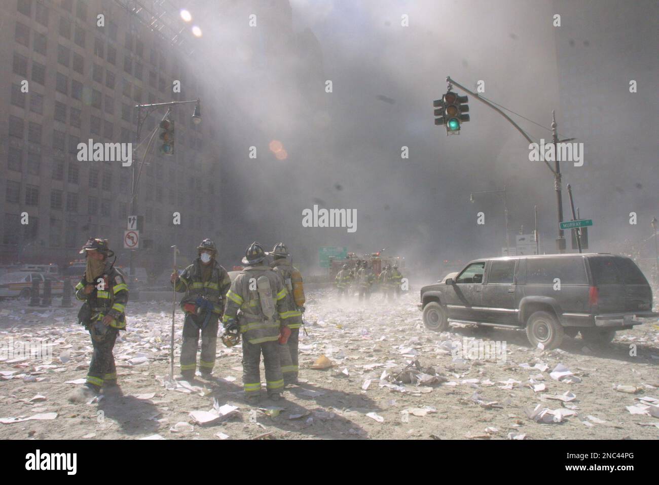 Emergency crews survey the damage after the fall of the twin towers on ...