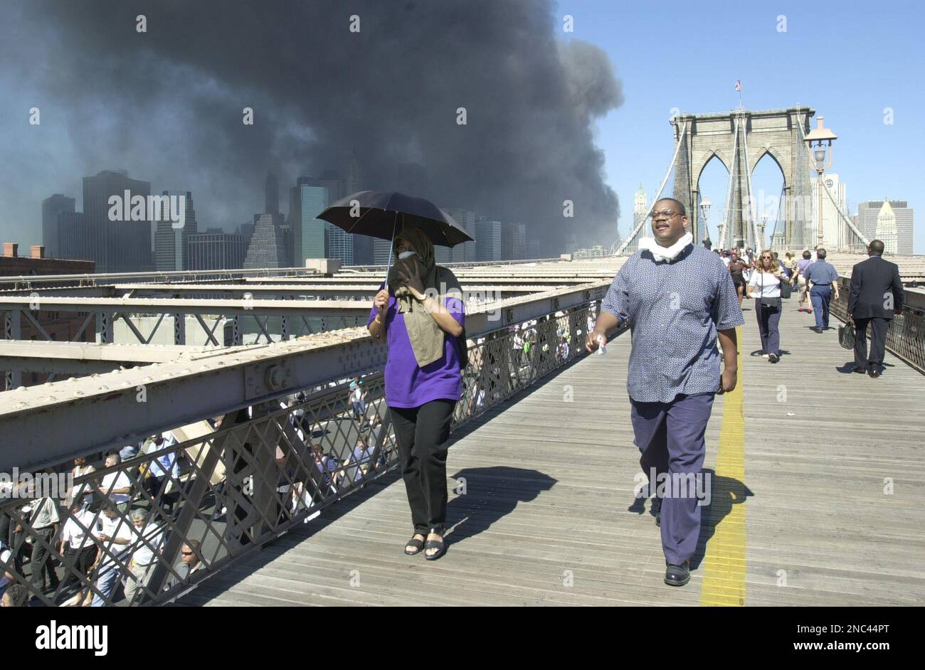 In this September 11, 2001 photo, people walk over New York's Brooklyn ...