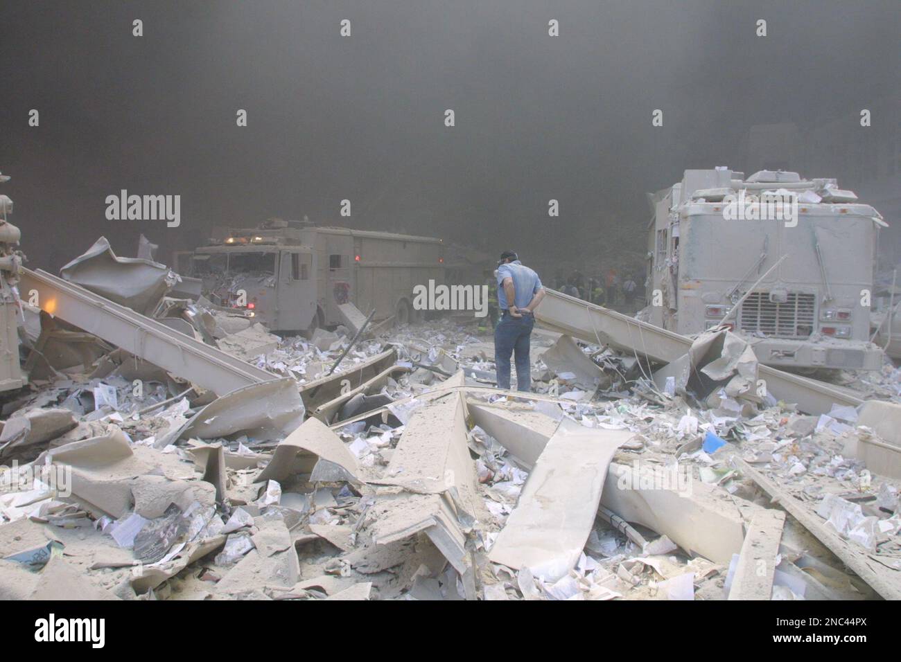 Firefighters walk through the rubble in the aftermath of the September ...