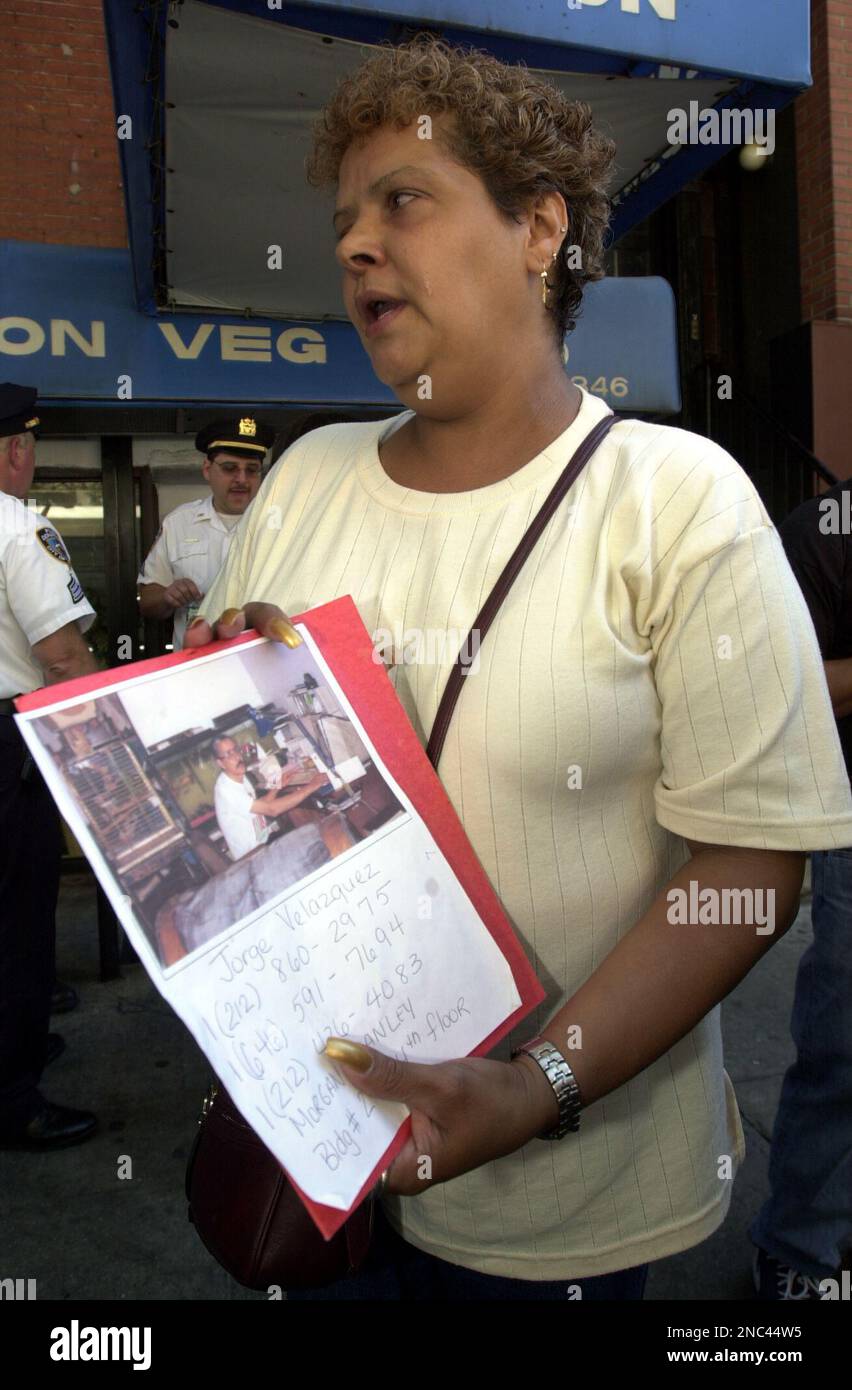 In this September 13, 2001 photograph, a woman poses with a picture of ...
