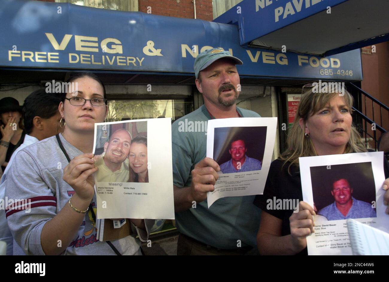 In this September 13, 2001 photograph, people pose with a pictures of a ...
