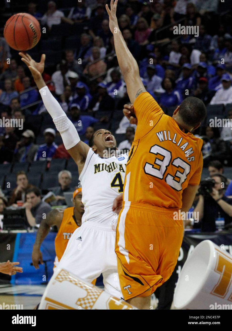 Michigan guard Darius Morris (4) shoots under pressure from Tennessee ...