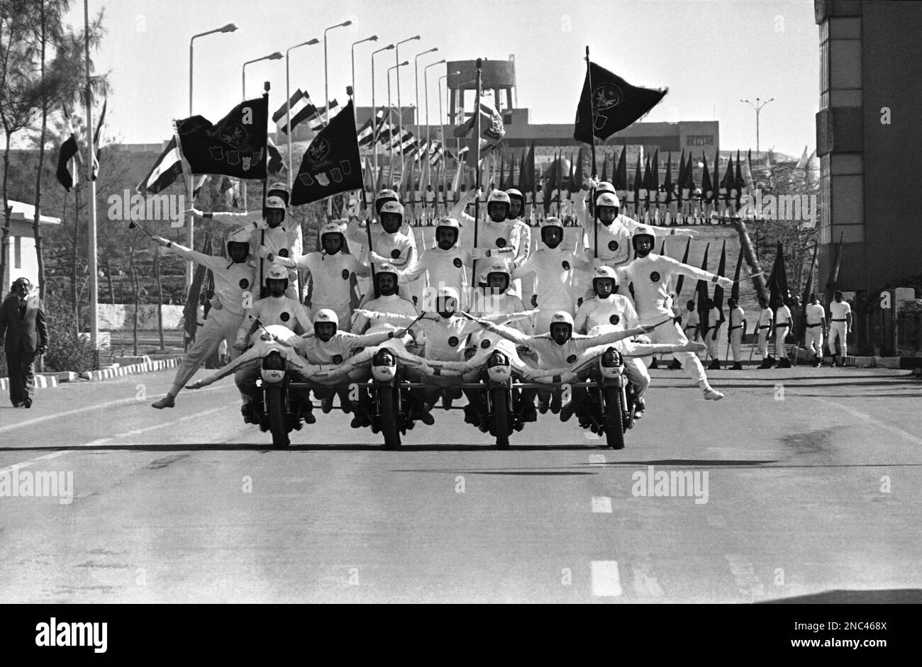 Egyptian police motorcycle team perform balancing trick during the ...
