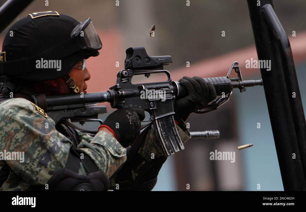 A Mexican army special forces soldier fires his gun during an exercise ...