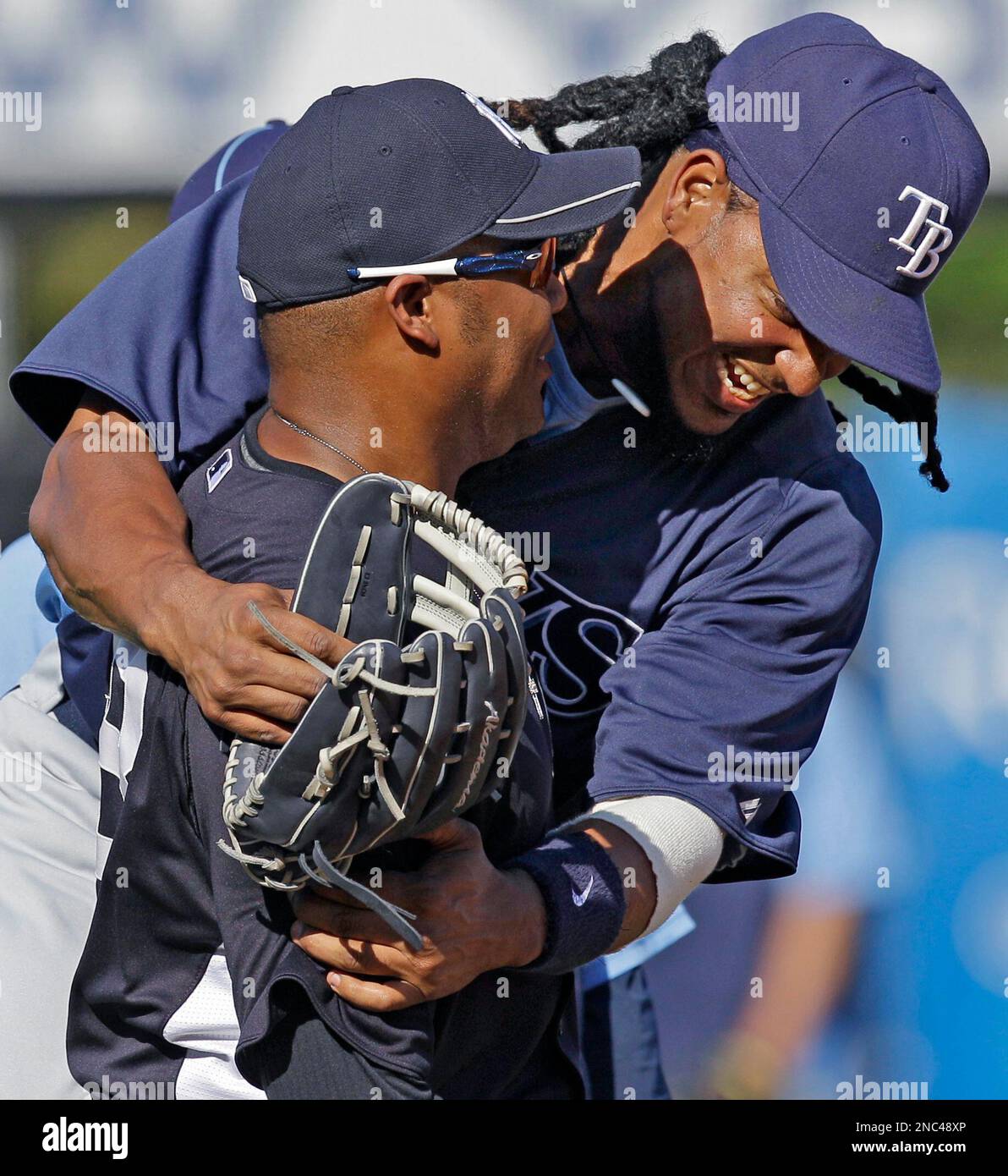 Tampa Bay Rays left fielder Manny Ramirez (24) gives a leaping bear hug ...