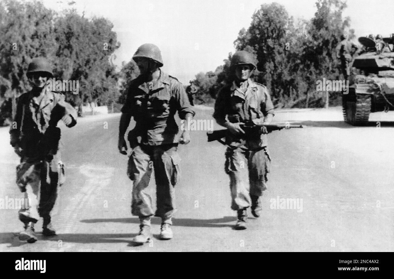 French soldiers, supported by tank, right, patrol road in Bizerte area ...