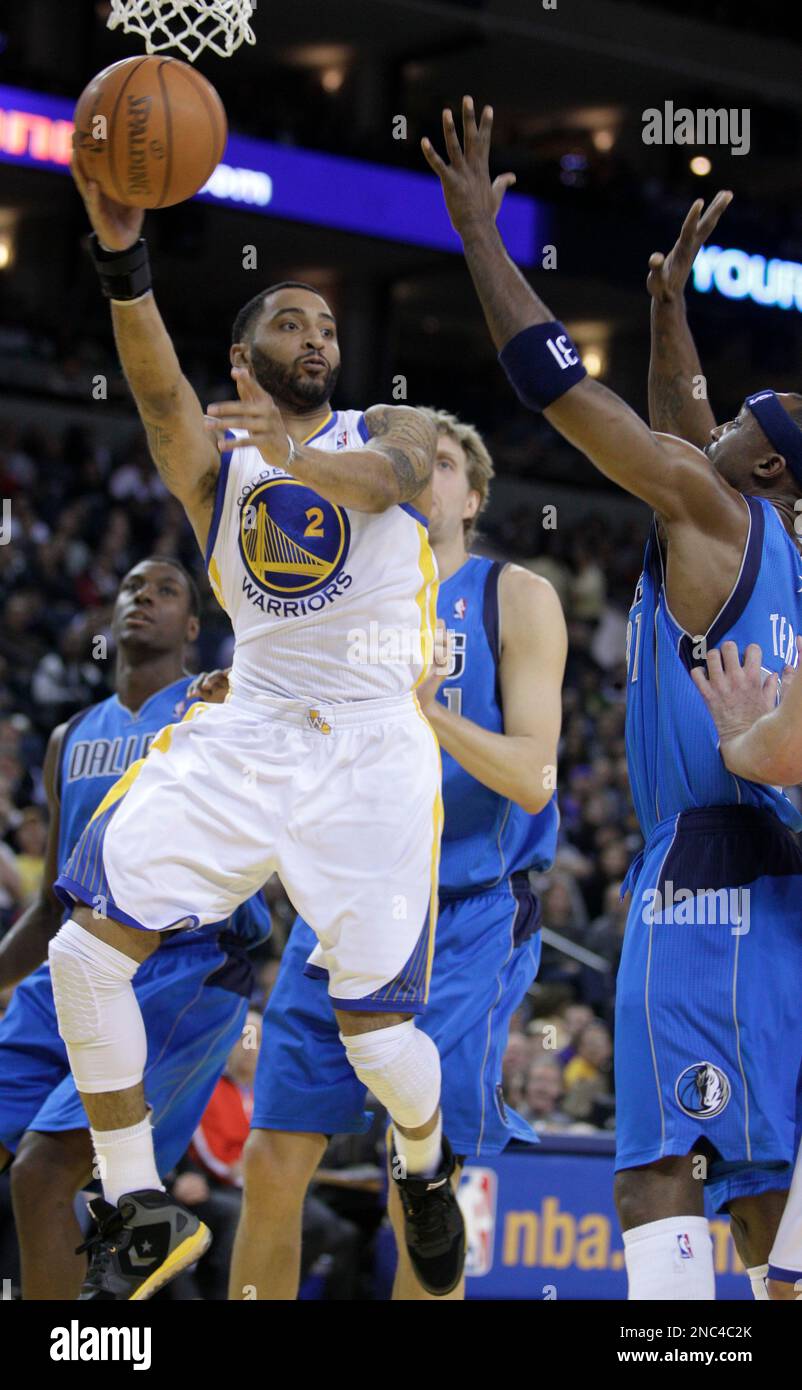 Golden State Warriors' Acie Law, left, passes the ball away from Dallas ...