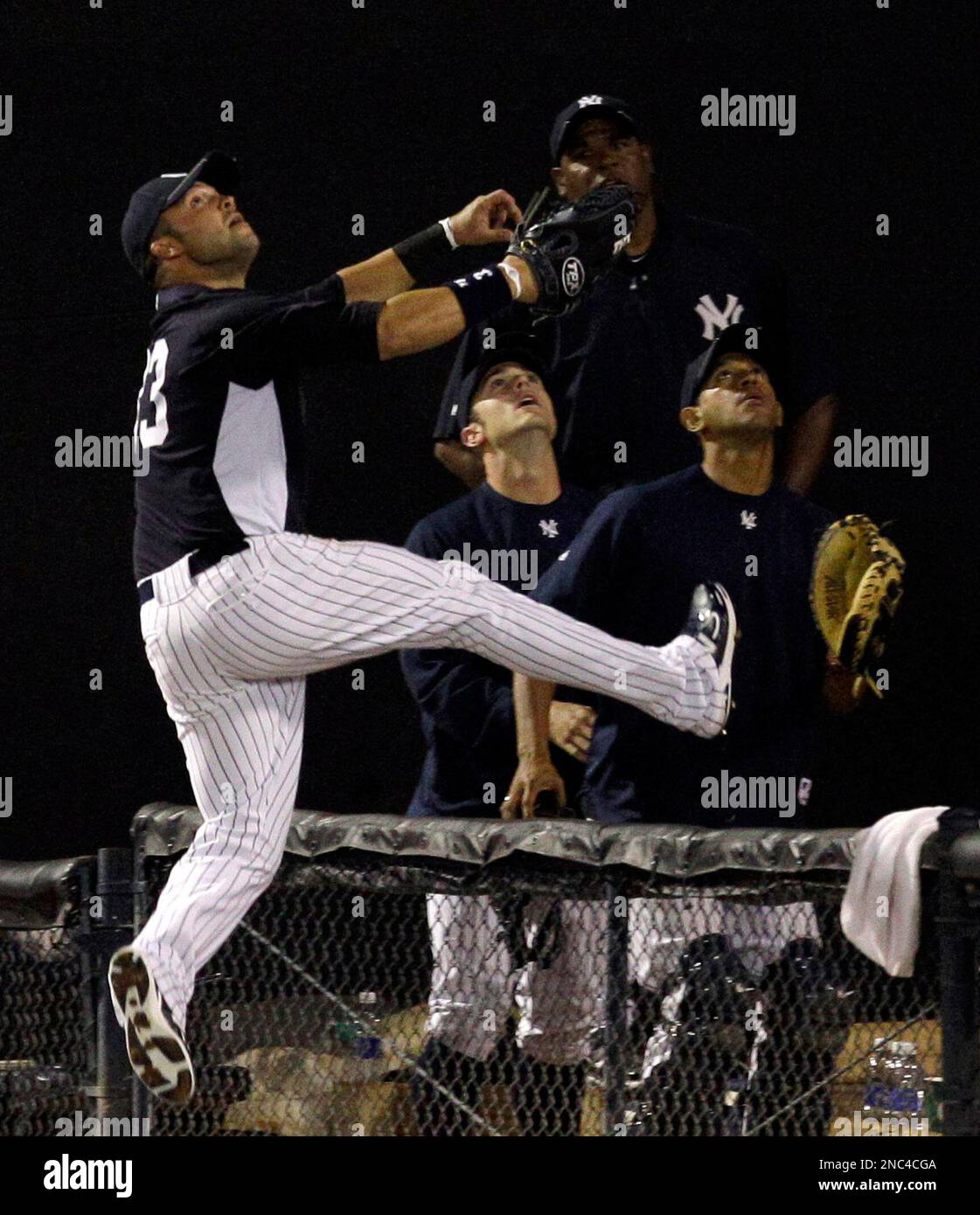 New York Yankees bullpen coach Mike Harkey, rear, watches as right ...