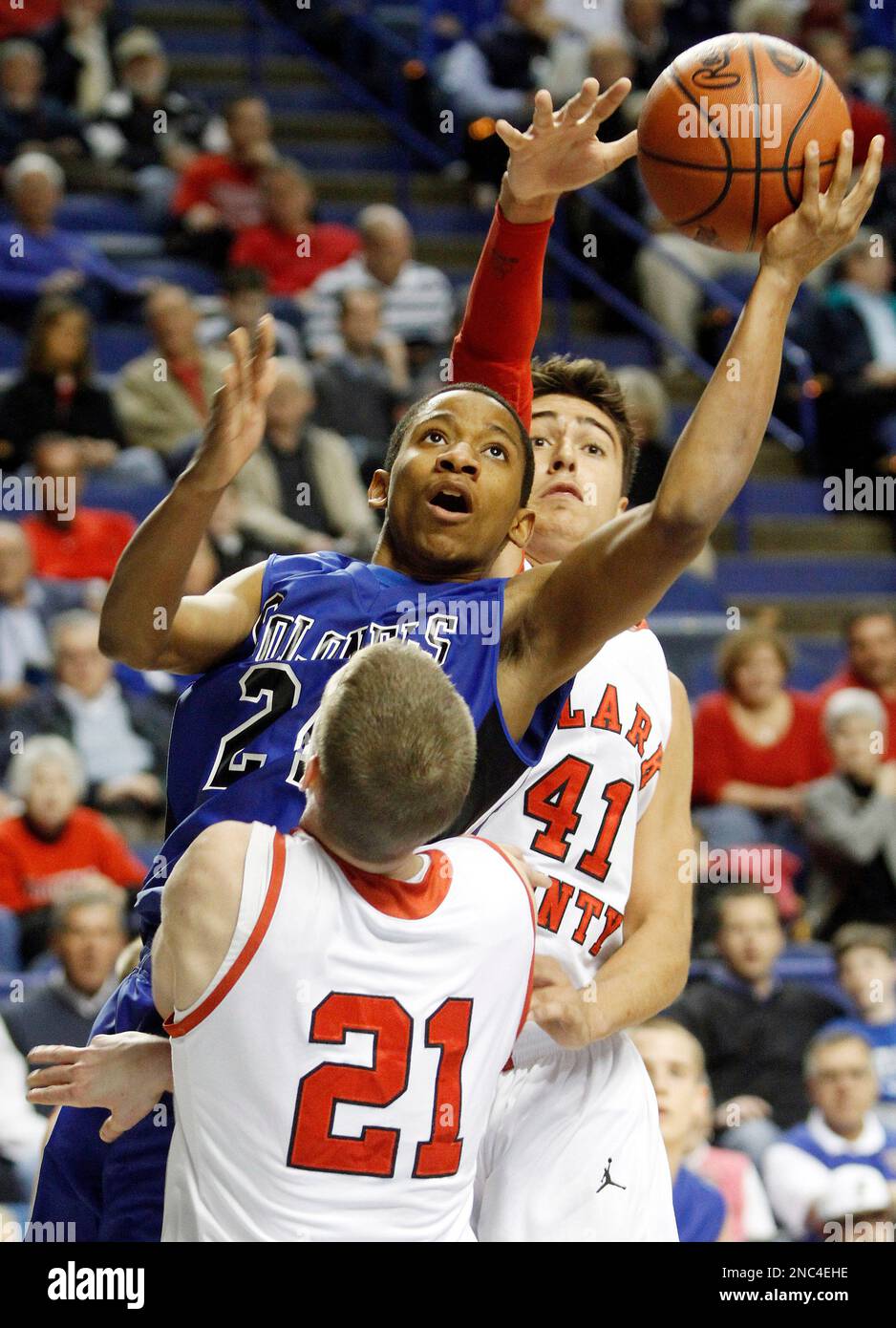 Oldham County's Blake Payne shoots between Clark County's Vinny Zollo ...