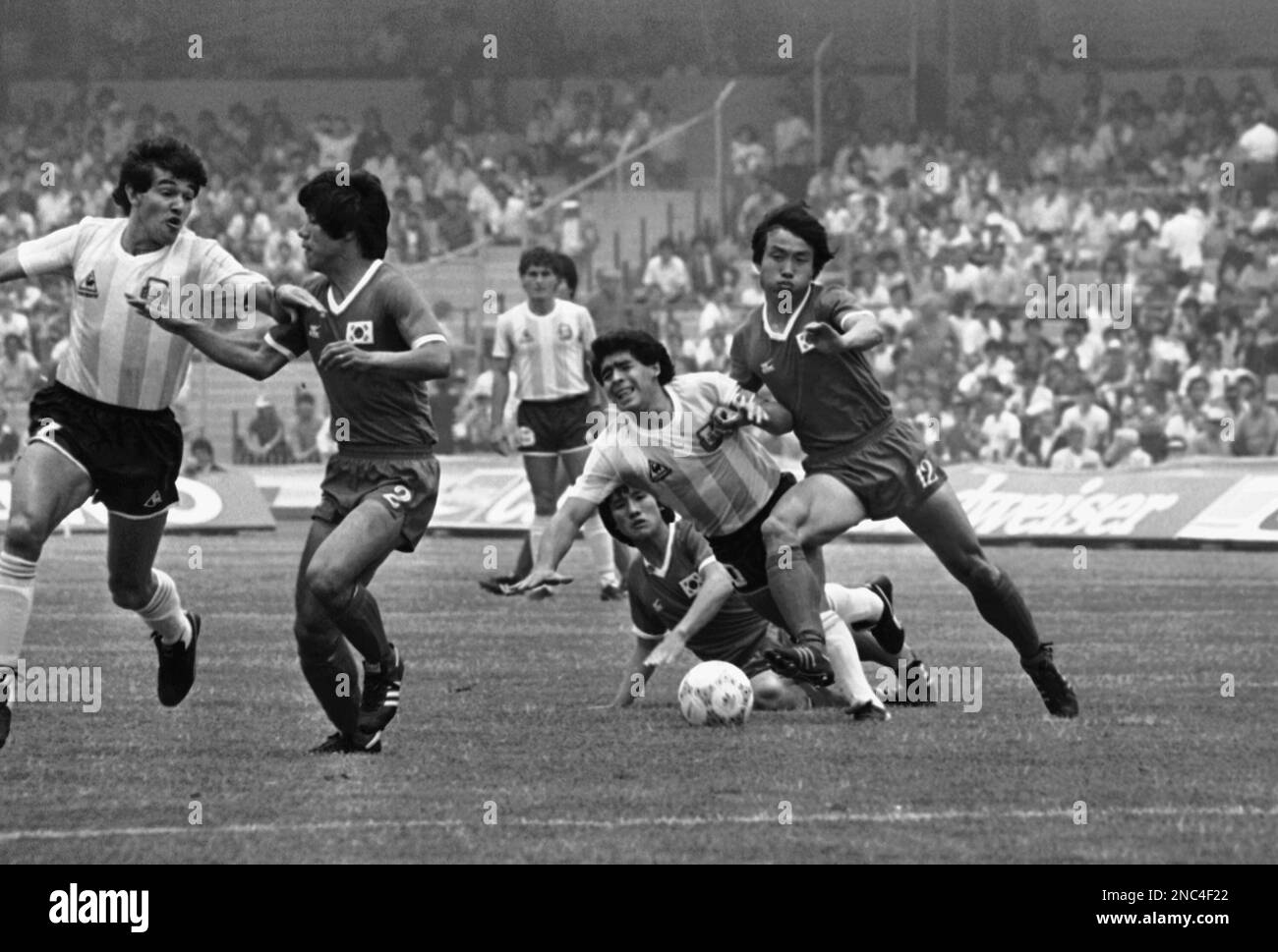 Argentina's Diego Maradona, centre, is fouled by Kim Pyung Seok, right ...