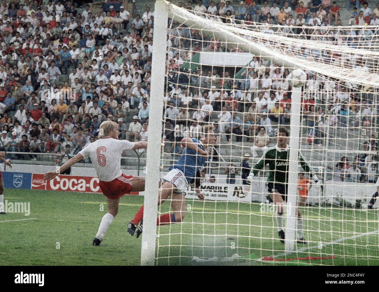 While Canadian goalkeeper Paul Dolan, background right, and back Ian ...
