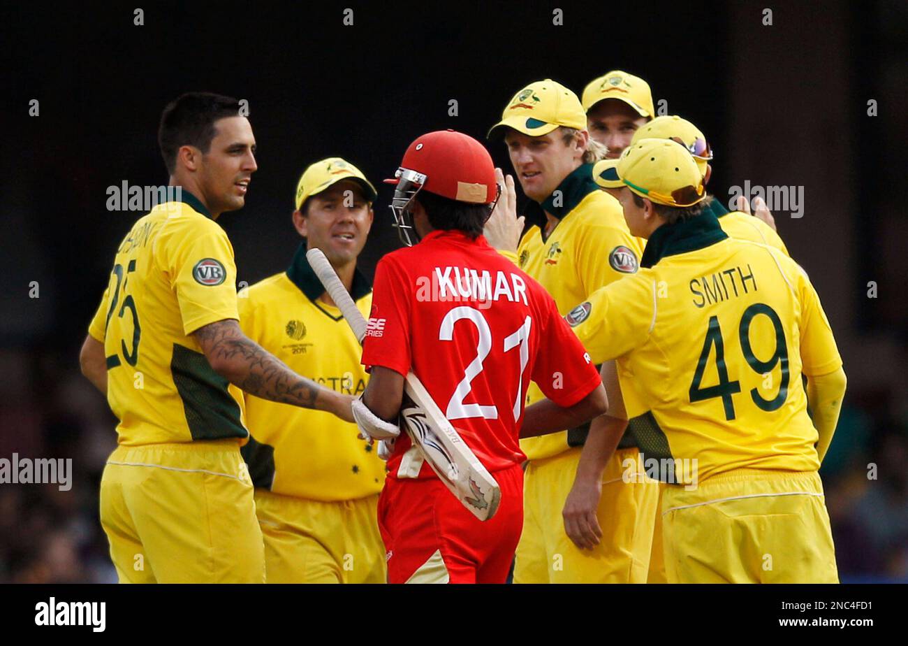 Canada's Satish Kumar, center, walks back as Australian cricketers ...
