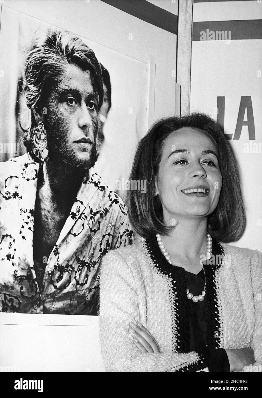 French actress Annie Girardot stands in front a of a picture from her ...
