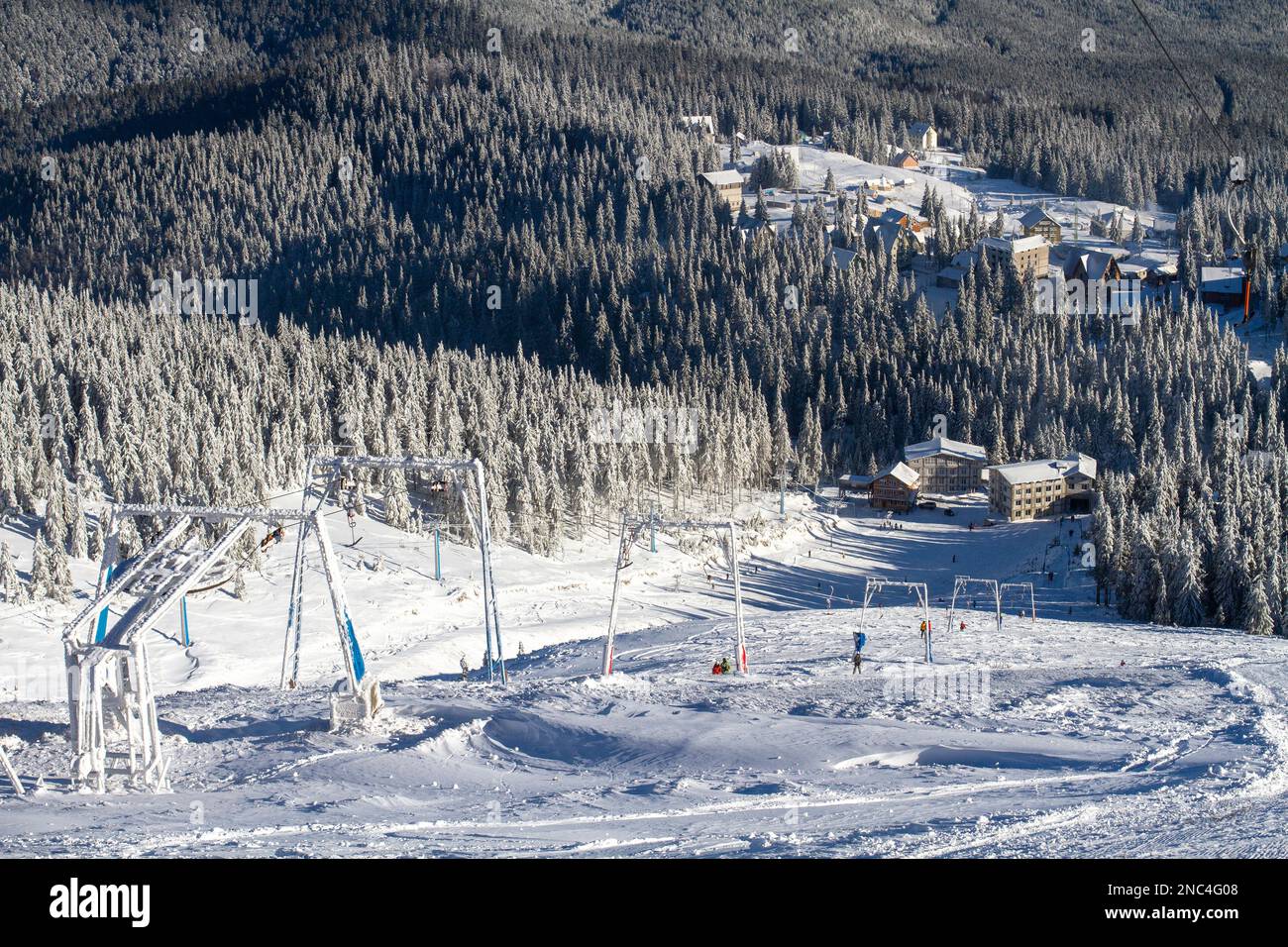 Cable and chair lift at a ski resort in the middle of the forest ...