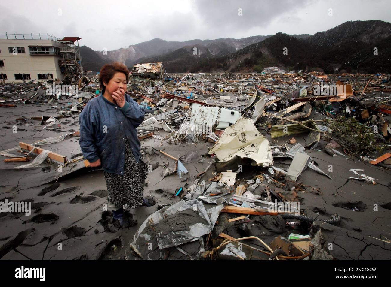Reiko Miura, 68, cries as she looks for her sister's son at a tsunami ...