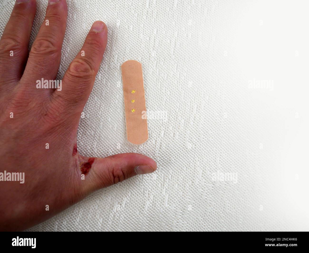 a human hand injured after a work accident, band-aid, band-aid to wrap ...