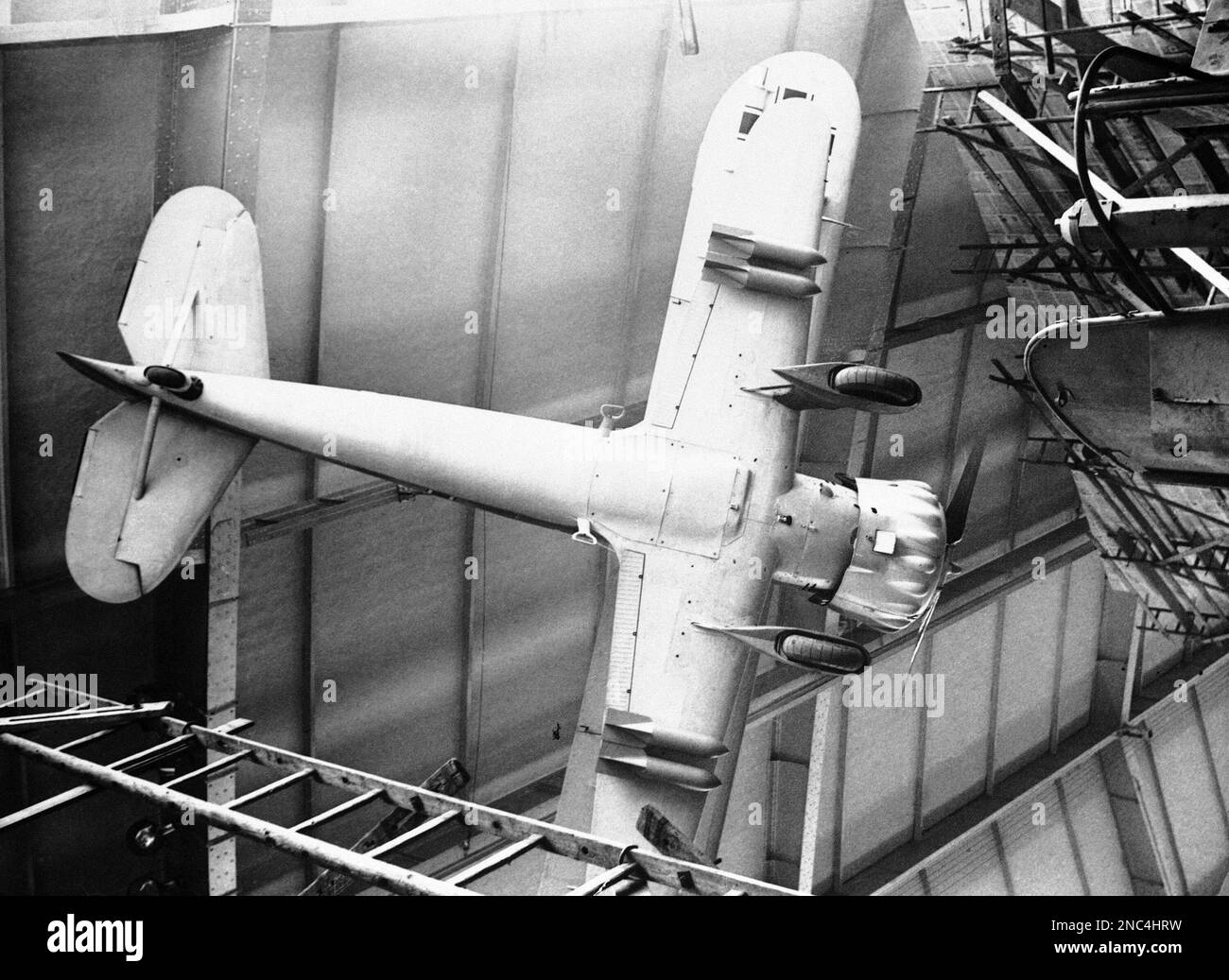 Army bombing plane, carrying its bombs under the lower wings, is ...