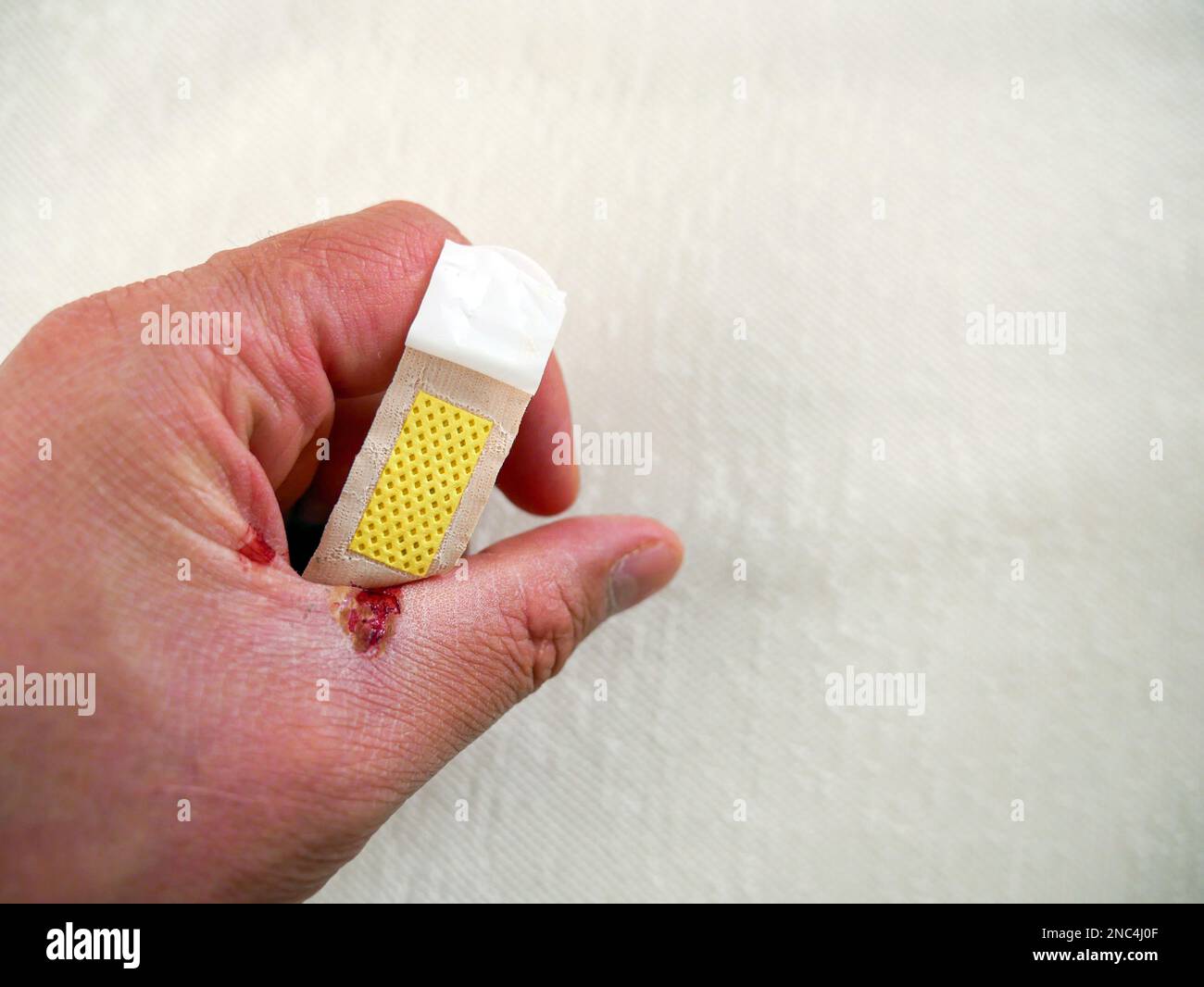 a human hand injured after a work accident, band-aid, band-aid to wrap ...