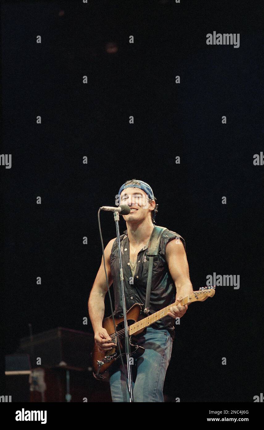 Bruce Springsteen smiles as he performs at the Los Angeles Coliseum ...