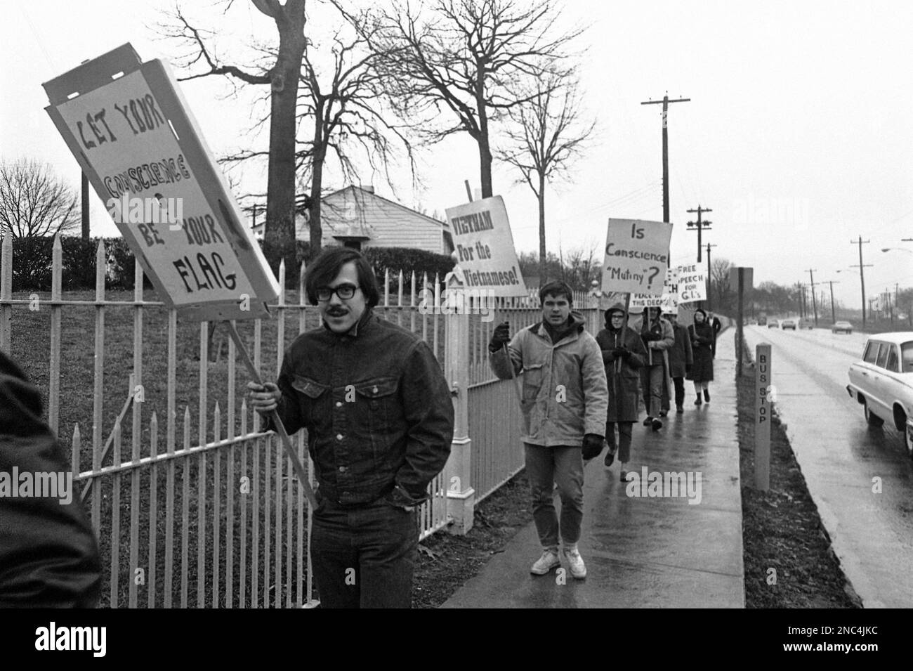 Pickets march past the fence around Fort McPherson in Atlanta, Georgia ...