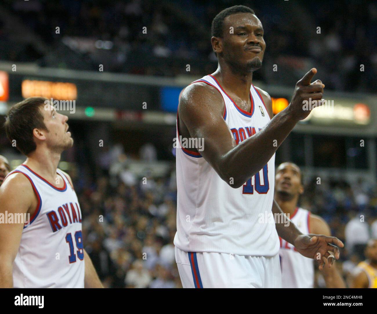 Sacramento Kings center Samuel Dalembert points to the Kings bench ...