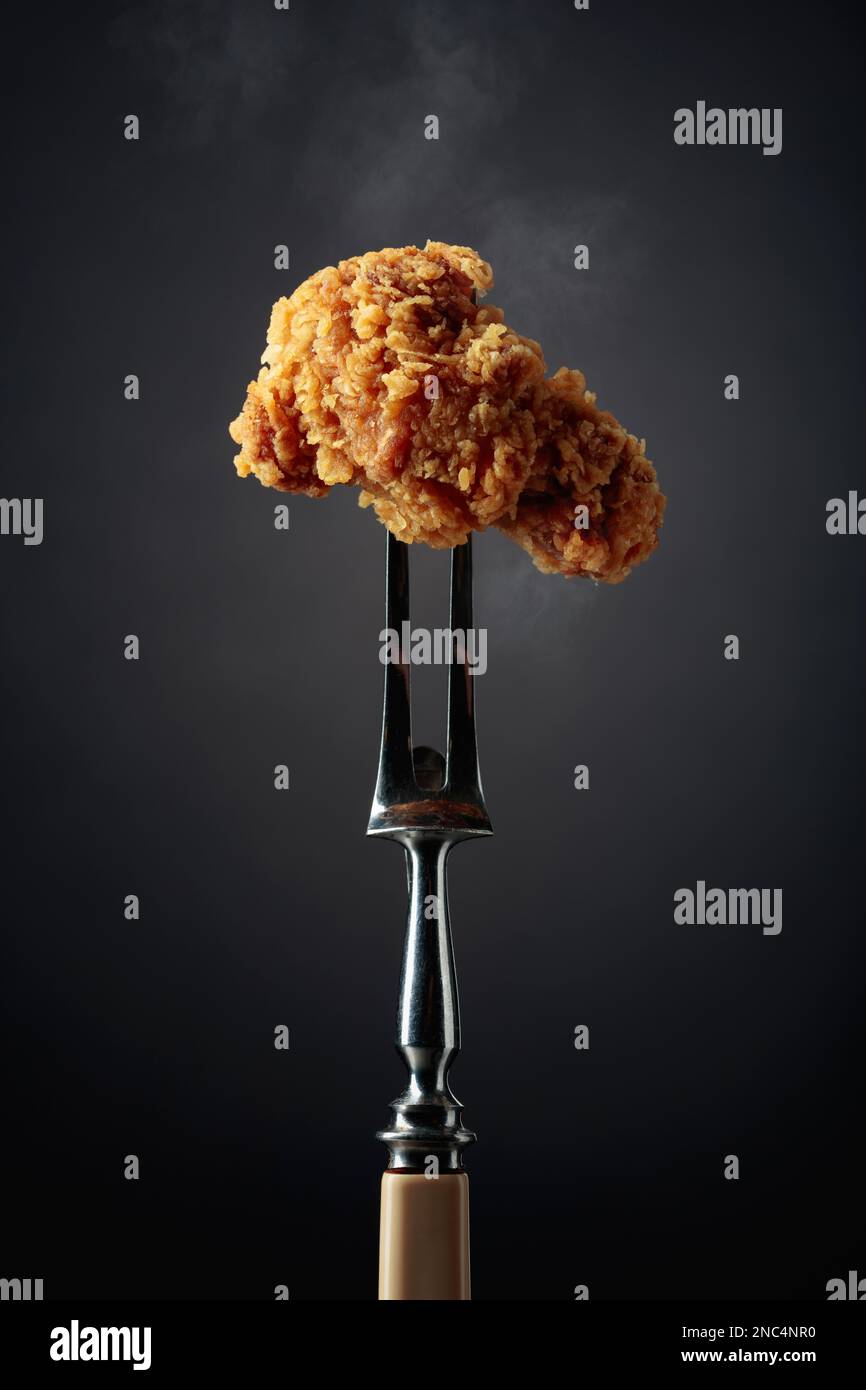 Delicious hot crispy fried chicken on a fork Stock Photo - Alamy