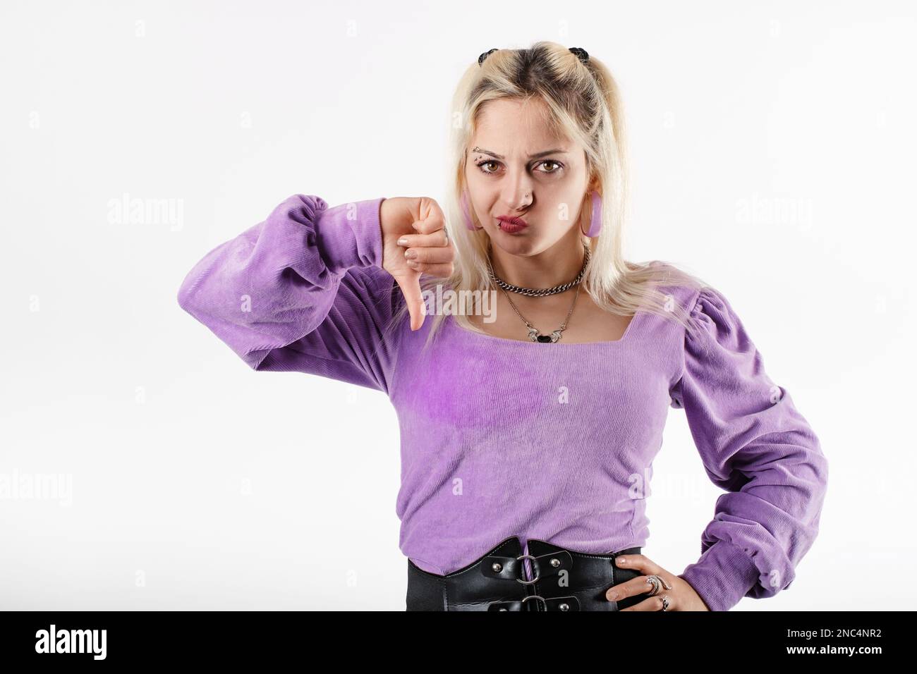 Young beautiful woman wearing lilac ribbed blouse isolated over white ...