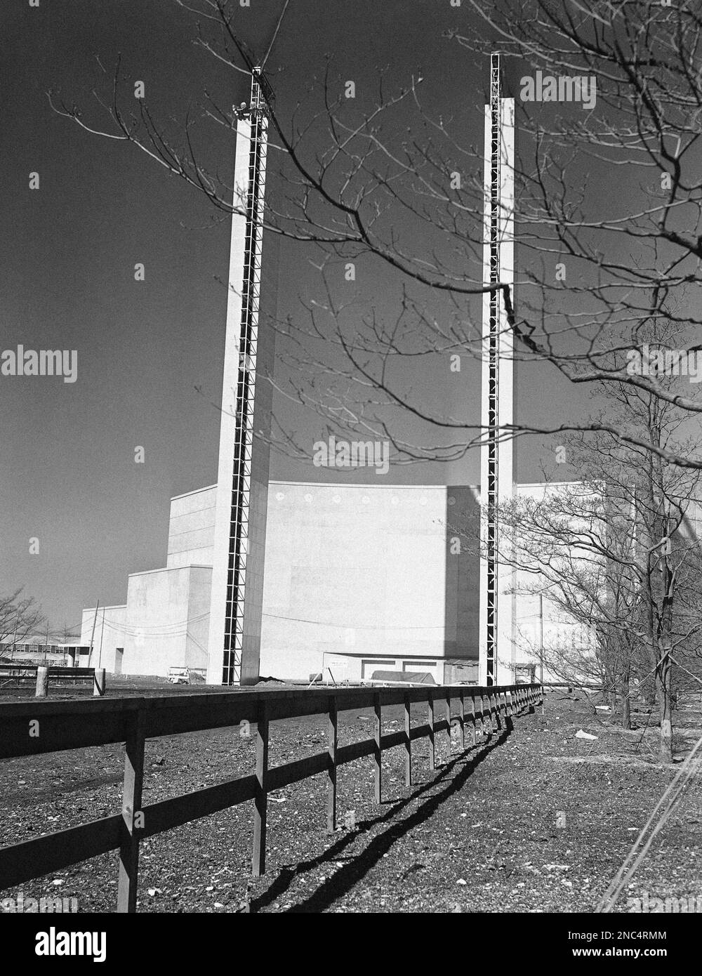 Two towering rectangular towers beside a squat and massive structure ...
