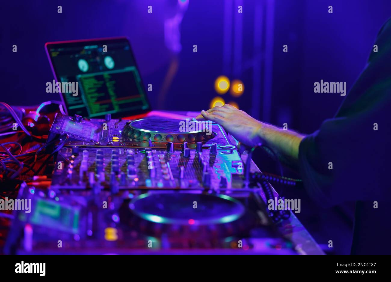 Club DJ playing music set on party. Disc jockey mixing musical tracks ...