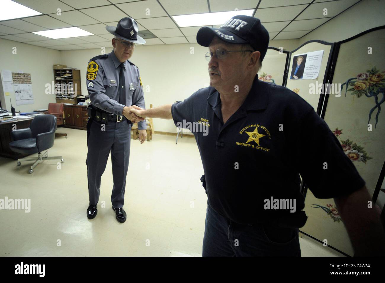 Buchannan County Sheriff Ray Foster, right, is consoled by Sgt. Steve ...