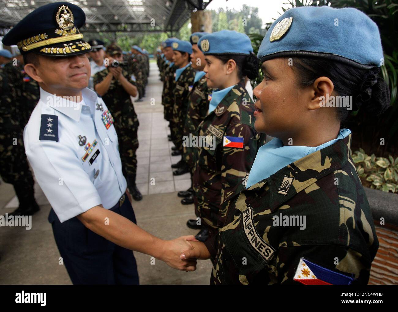 Philippine military chief Lt. Gen. Eduardo Oban Jr., left, shakes hands ...