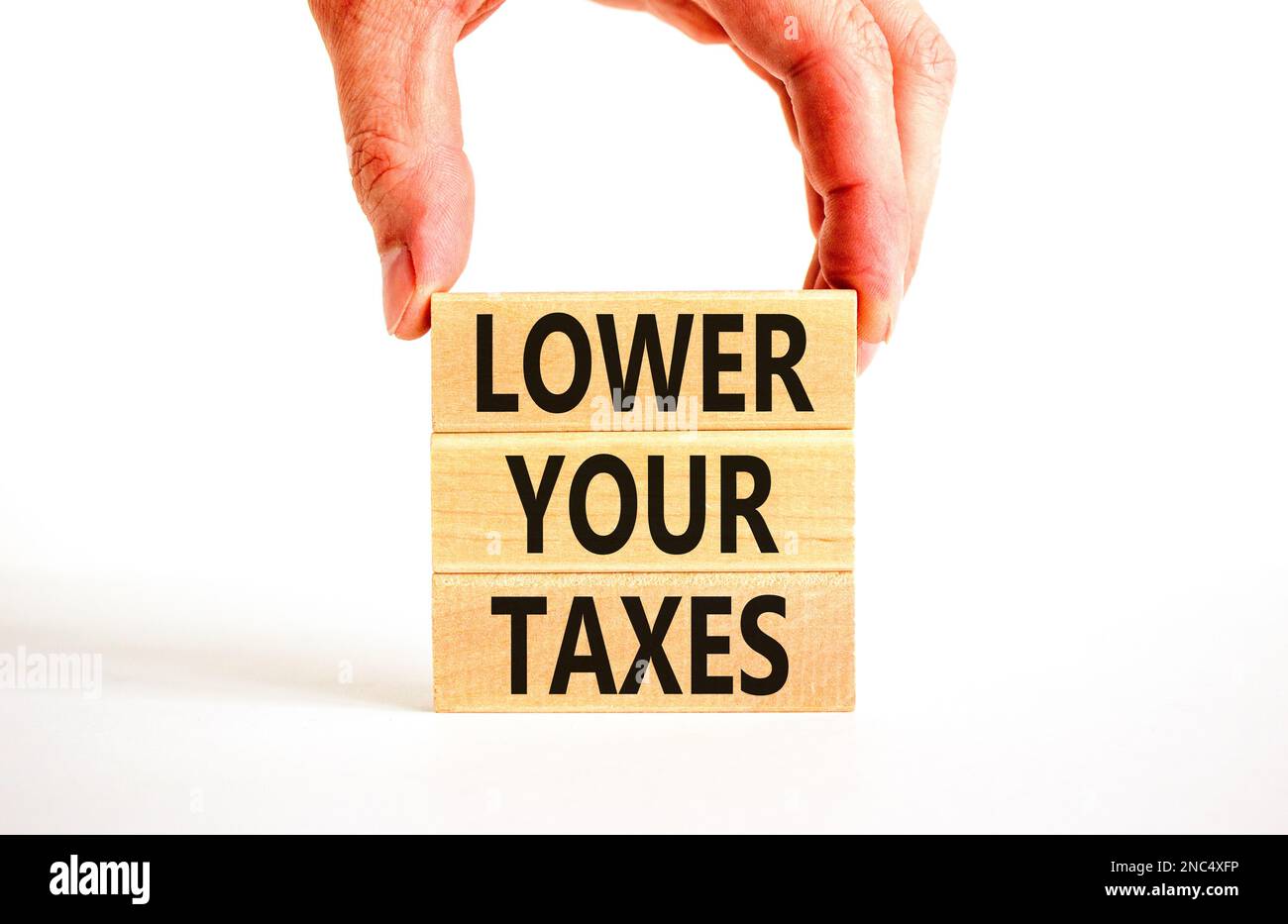 Lower your taxes symbol. Concept words Lower your taxes on wooden ...