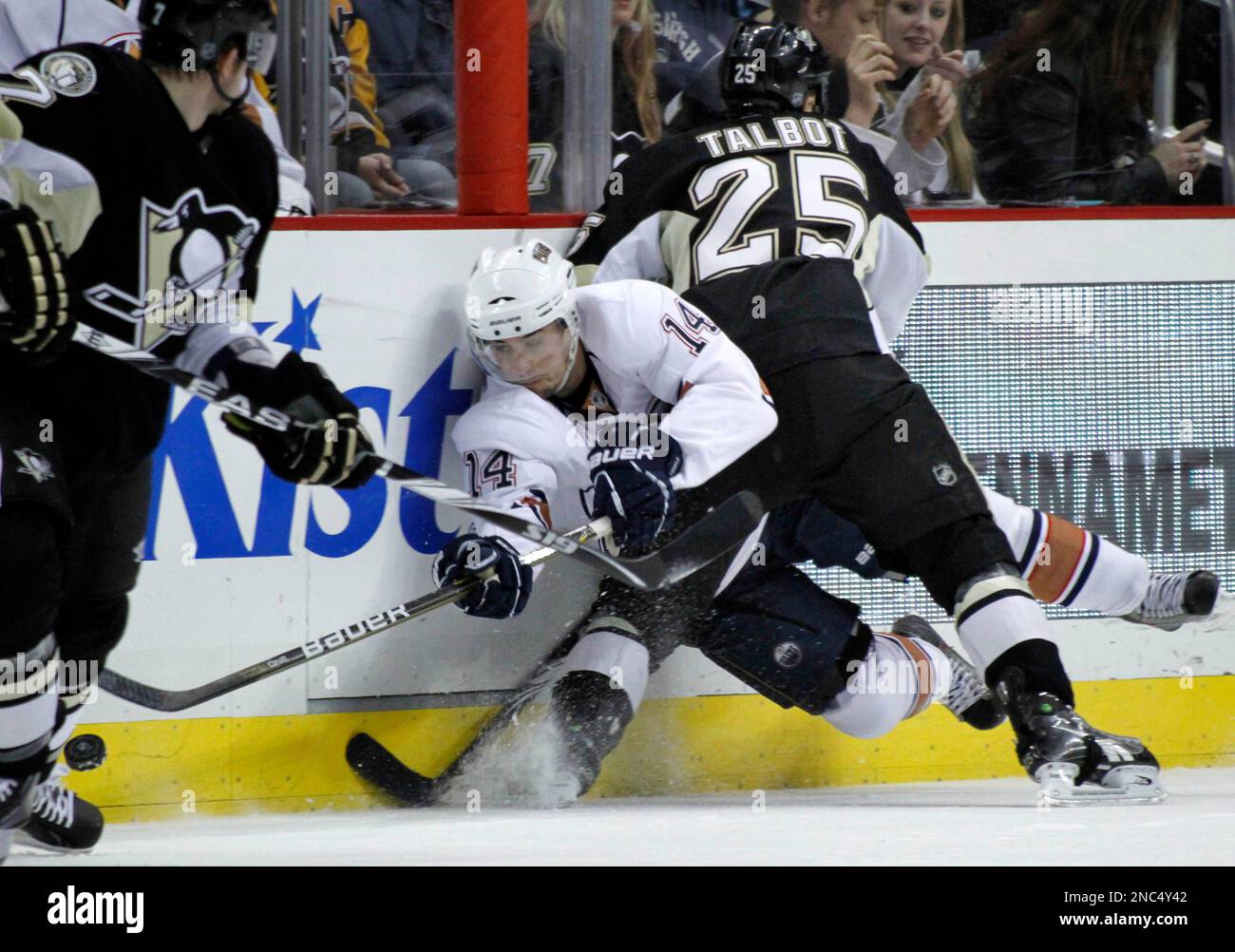 Edmonton Oilers' Jordan Eberle (14) tries to get the puck as he is ...