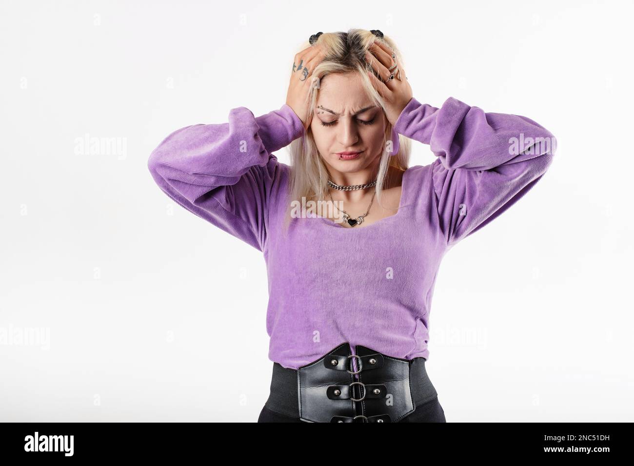 Portrait of young woman wearing lilac blouse isolated over white ...