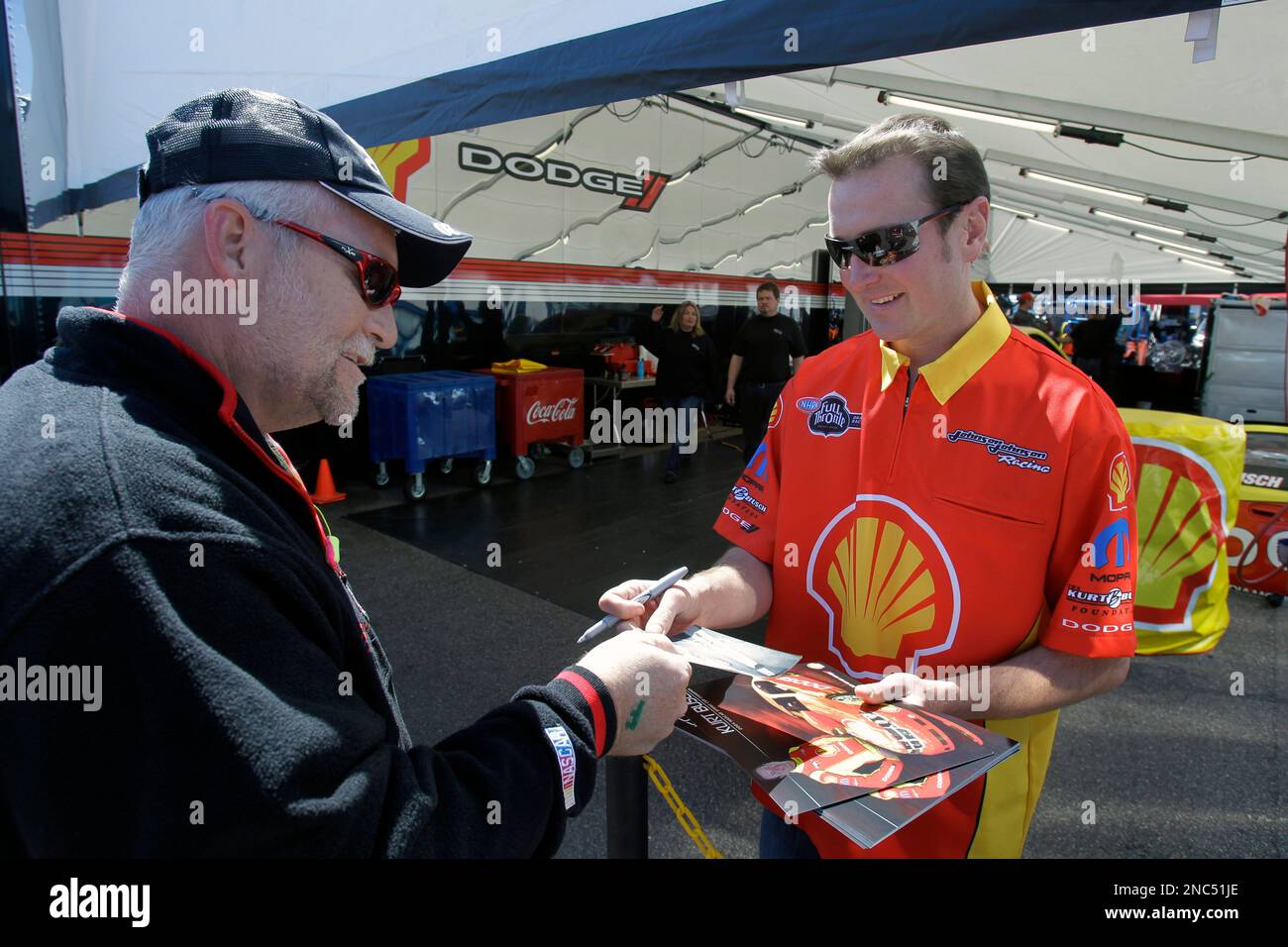 Kurt Busch signs an autograph before going out on his second attempt to ...