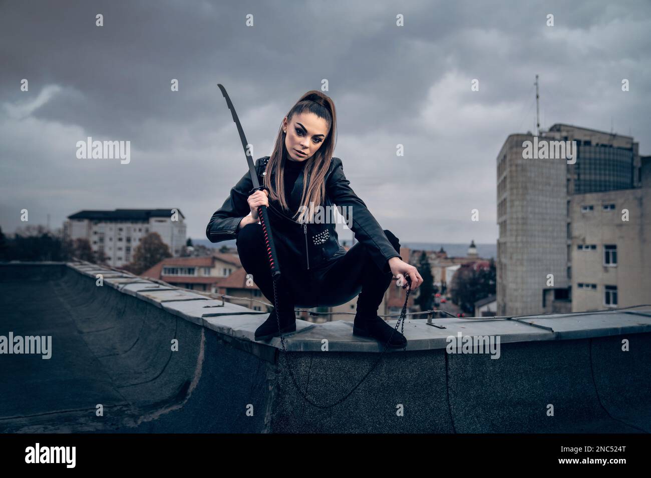 A cool female ninja warrior in leather outfit wielding a Japanese sword ...