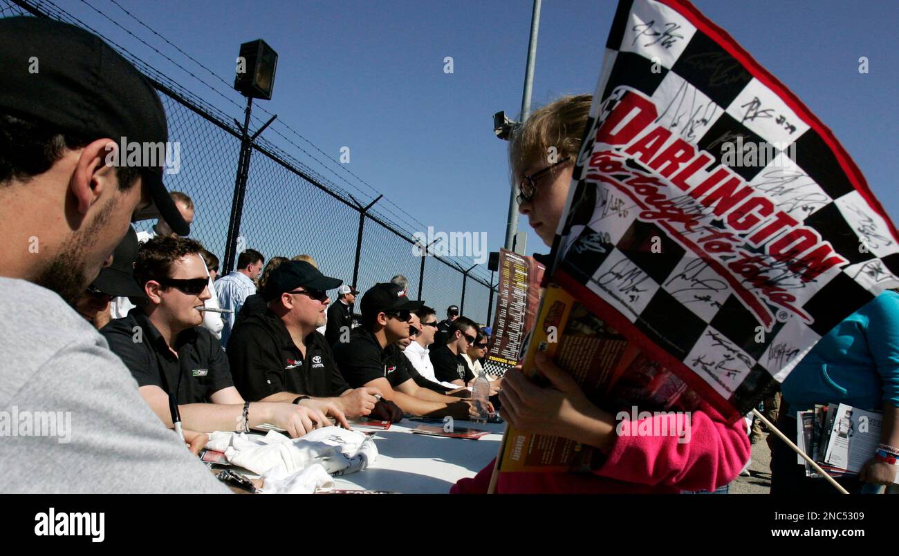 A young fan gets her flag signed by NASCAR drivers before the start of ...