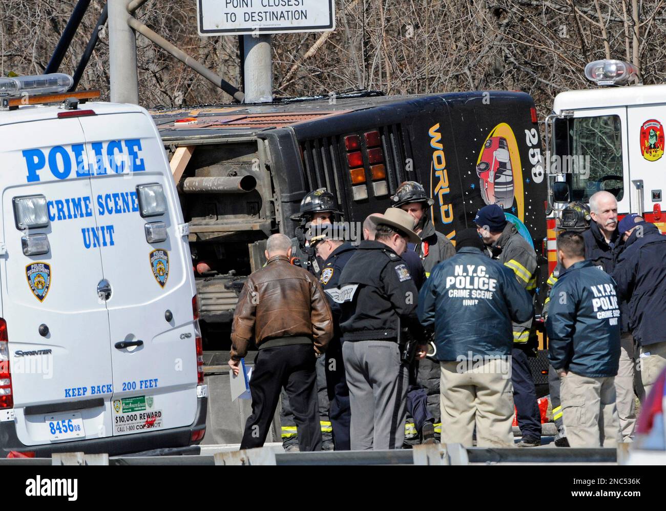 Emergency personnel investigate the scene of a bus crash on Interstate ...