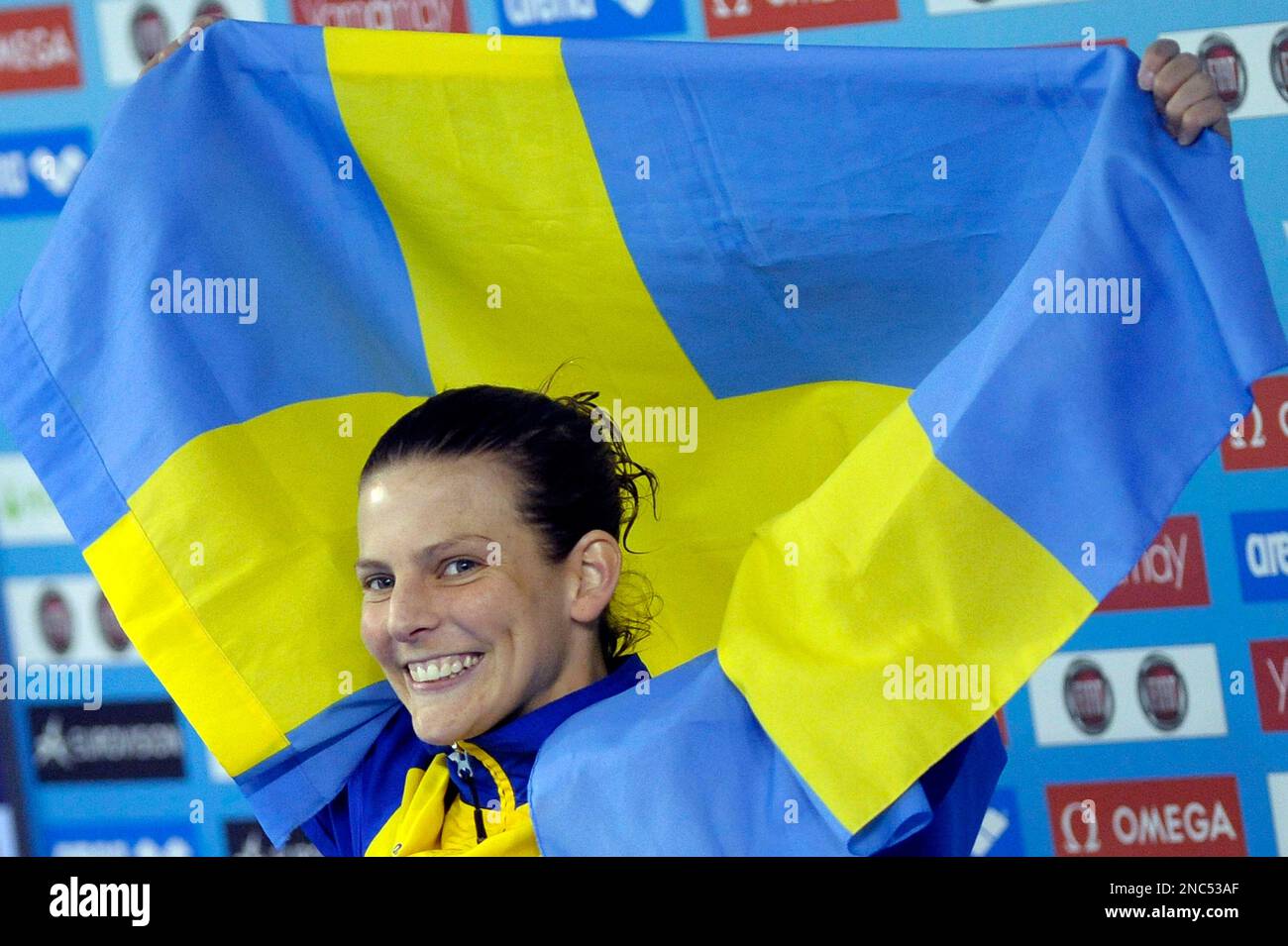 Sweden's Anna Lindberg celebrates with a national flag after winning ...