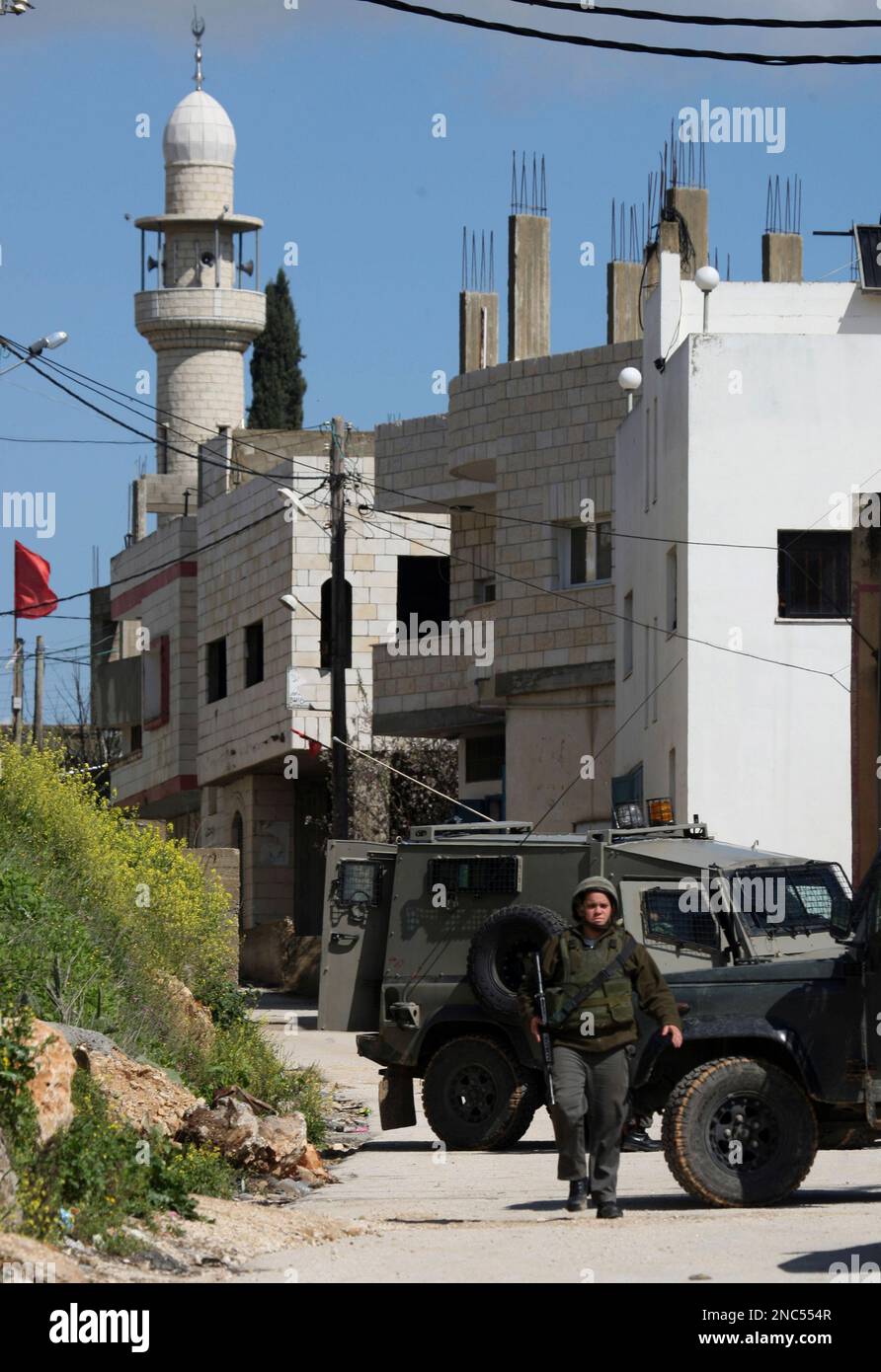 Israeli troops operate in the West Bank village of Awarta, after five ...