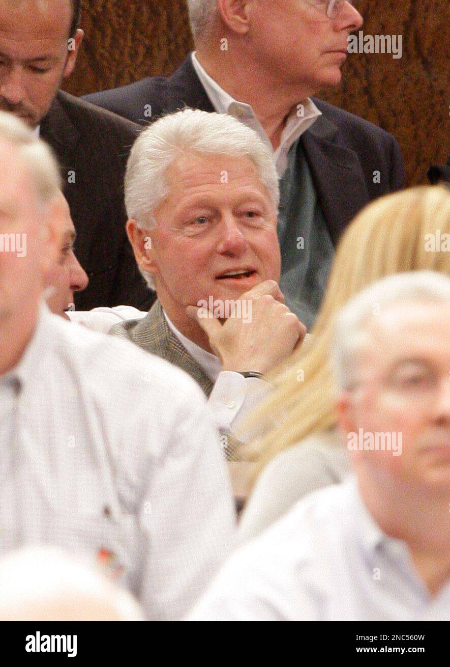 Former President Bill Clinton looks on during the first half of an NCAA ...