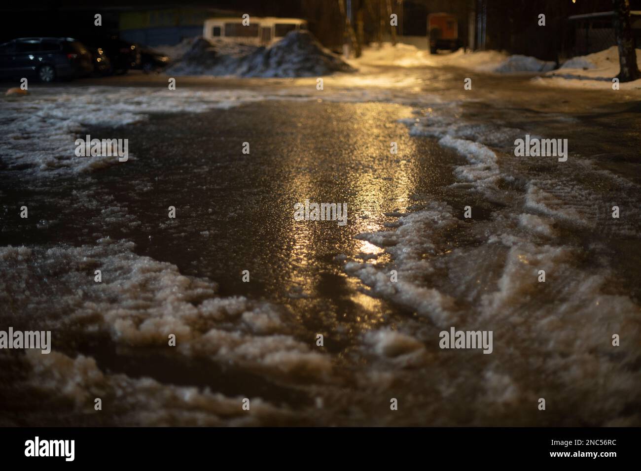 Big puddle at night. Lots of water in parking lot. Big puddle in city ...