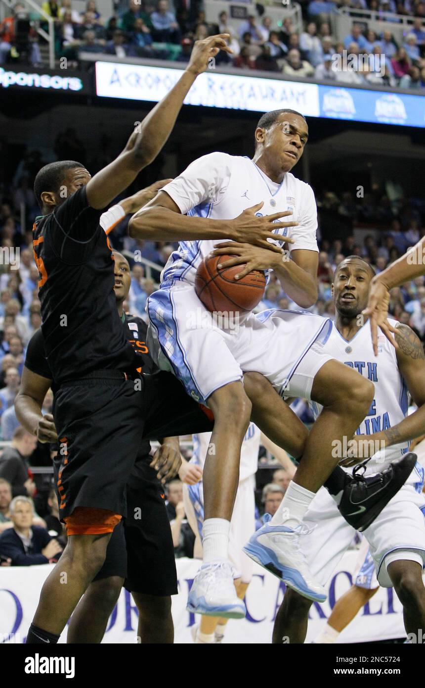 North Carolina's John Henson, right, battles with Miami's Garrius Adams ...