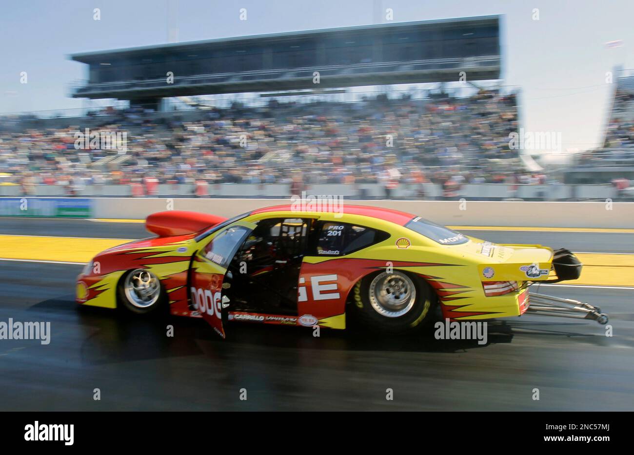 Kurt Busch backs his car to the starting line after heating up the ...