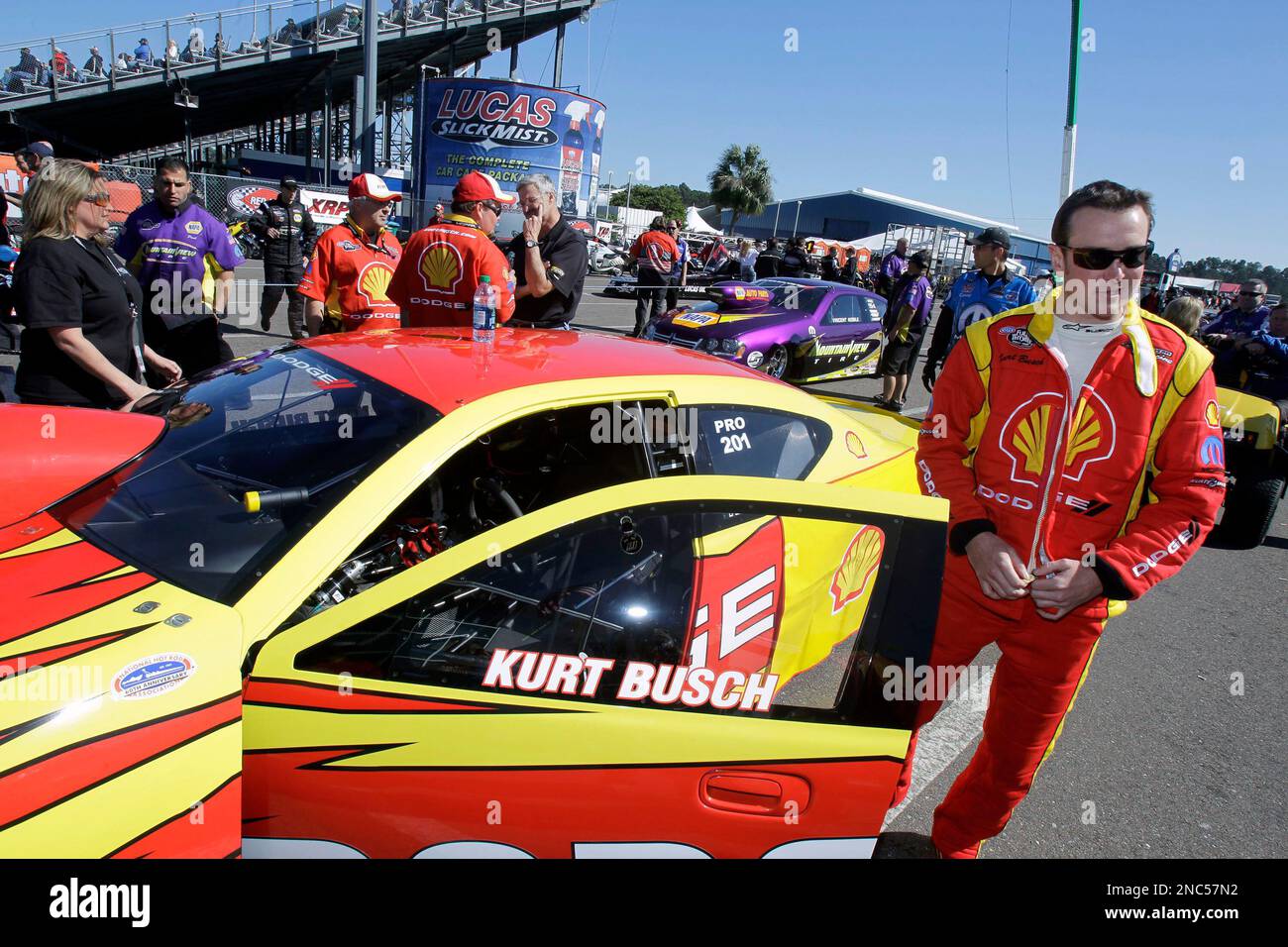 Kurt Busch stands by his car in the staging area before his second drag ...