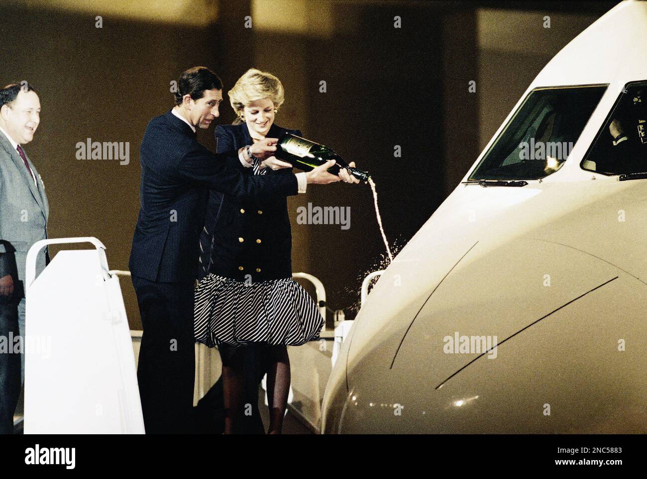 Prince Charles and Princess Diana of Wales pour champagne on the nose ...